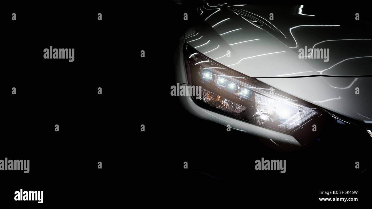 Modern car headlights on black background. Copy space Stock Photo - Alamy