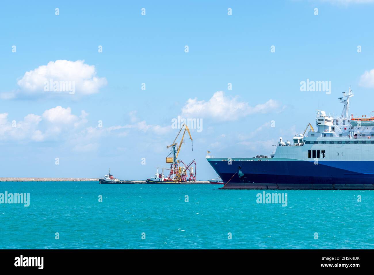 Boats in the seaport on the background cranes and containers Stock ...