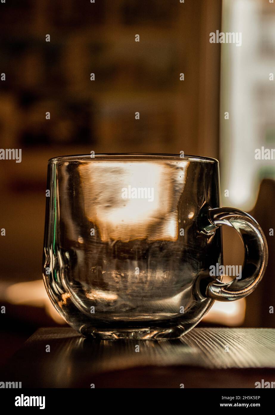 Vertical shot of an empty glass mug on the table Stock Photo - Alamy