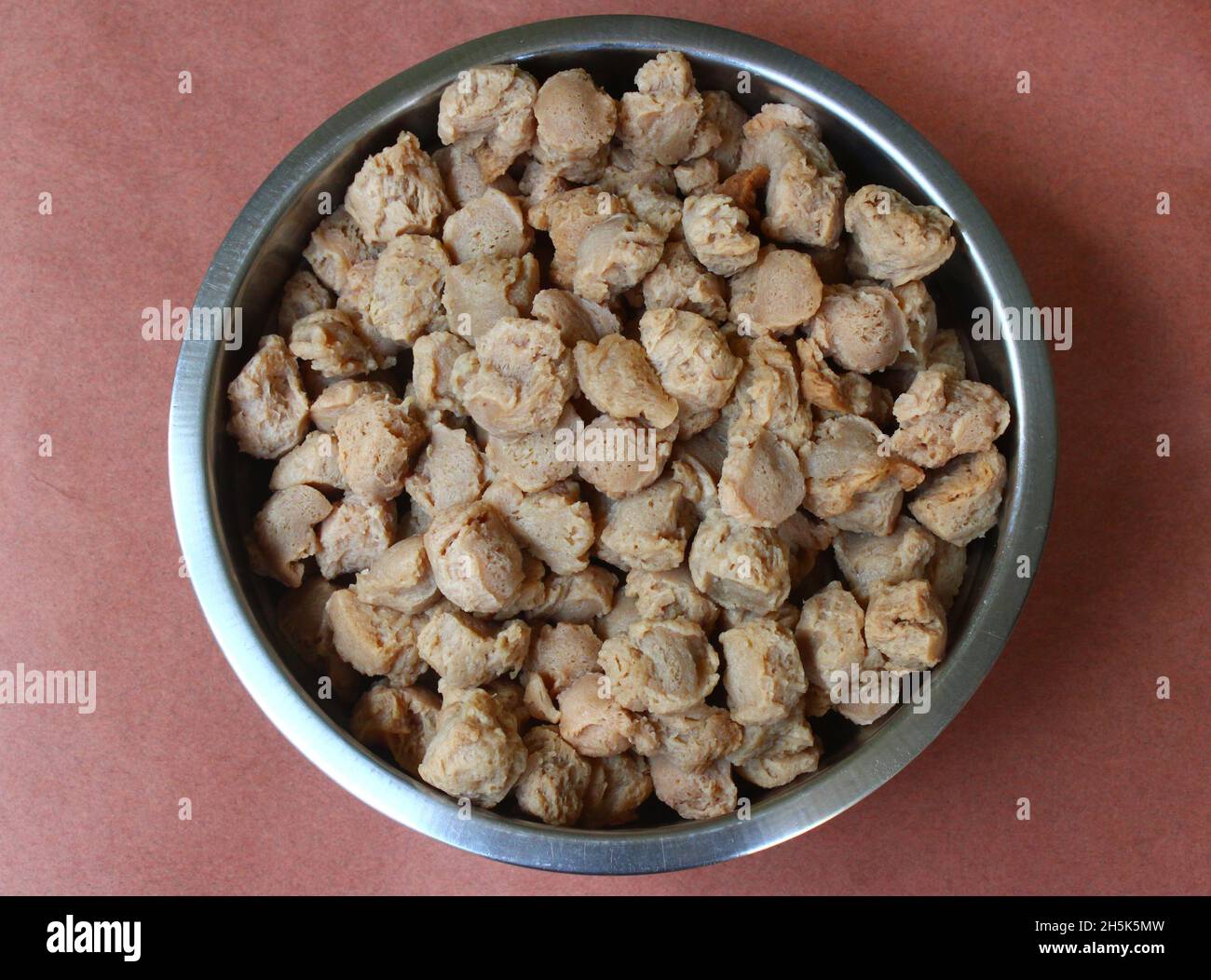 Boiled soya chunks in a steel bowl isolated on brown background Stock ...