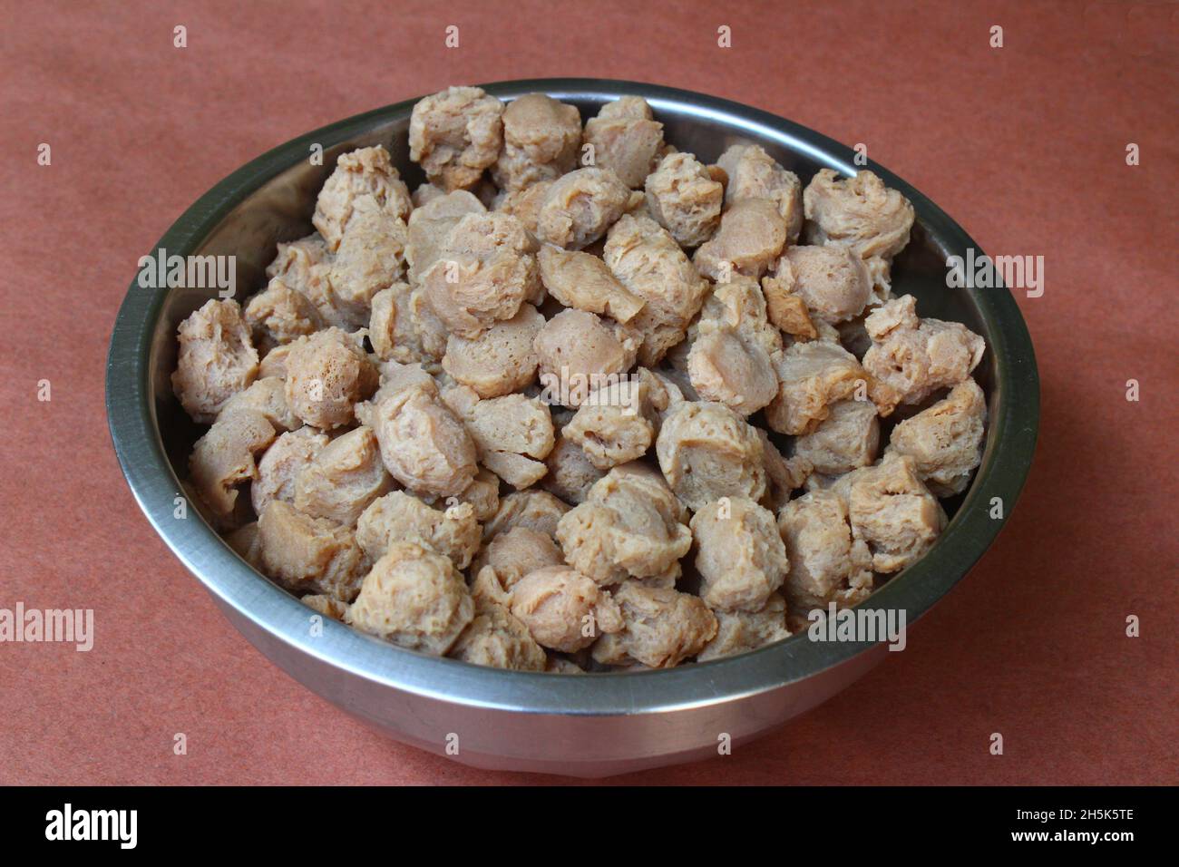 Boiled soya chunks in a steel bowl isolated on brown background Stock ...