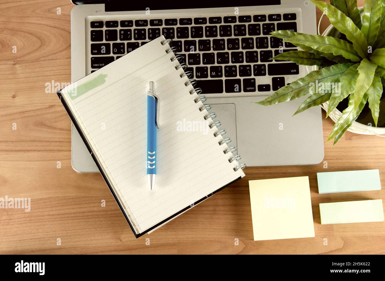 Office table with notepad, computer and supplies Stock Photo - Alamy