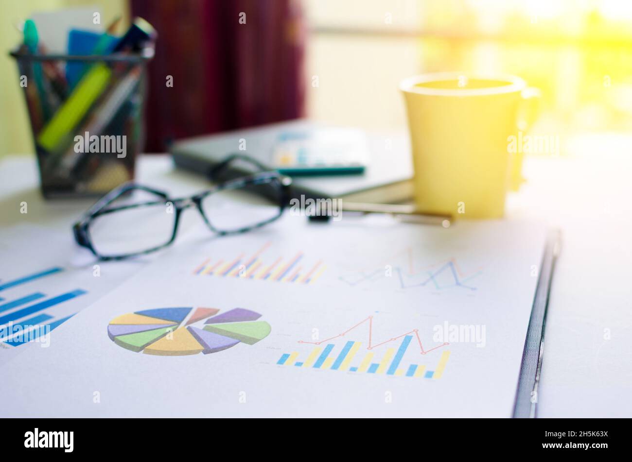 Papers with graphs, calculator. Finance concept Stock Photo - Alamy