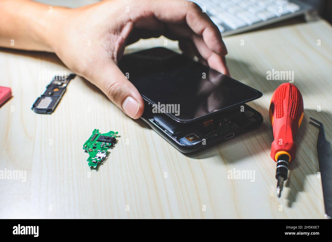 Technician mobile phone repairing fixing hi-res stock photography and ...