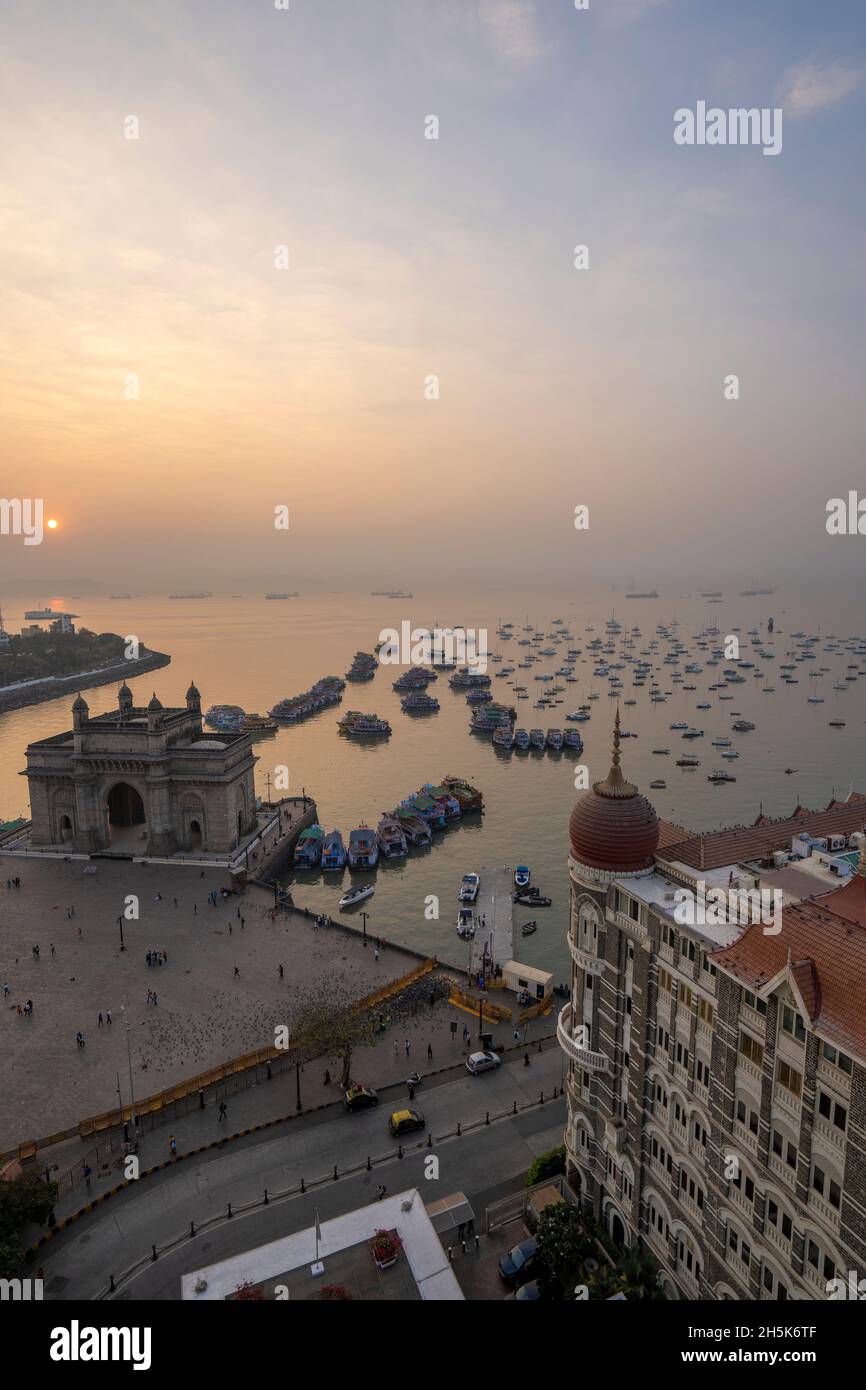 Sun rise over the harbor with the Gateway of India and the Taj Mahal Palace Hotel at dawn ...