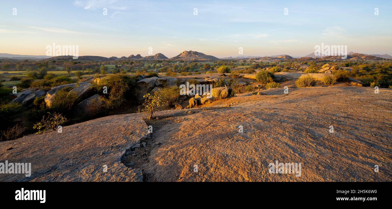 The landscape surrounding a dam lake with rock formations and plants of ...