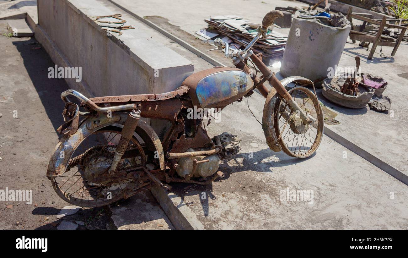 Rusty and broken old Japanese motorcycle destroyed due to Mount Merapi ...