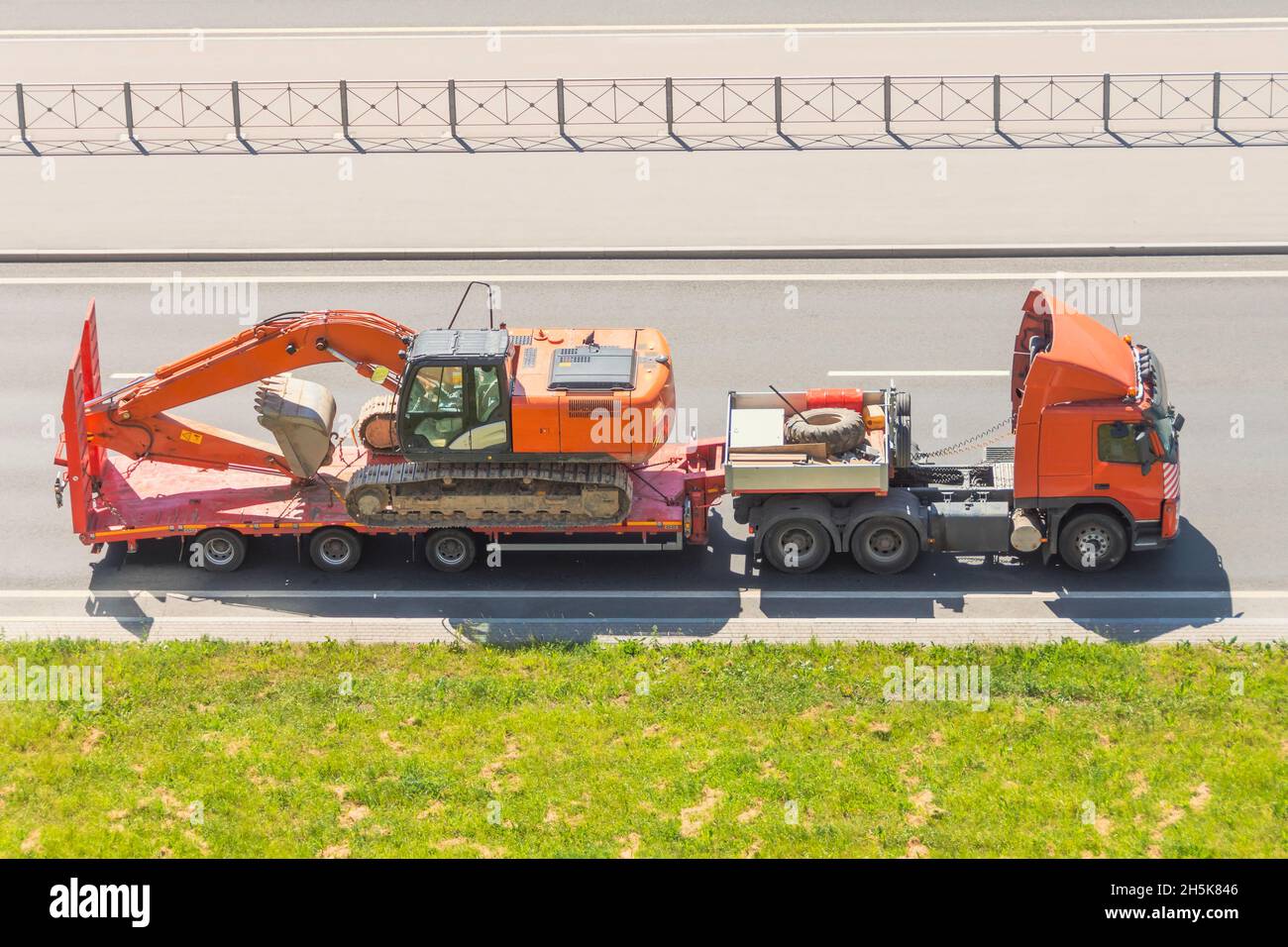 Earth mover backhoe on heavy duty flatbed vehicle for transported. Long ...