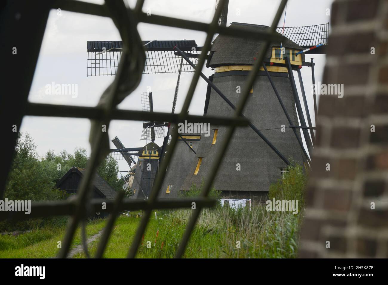 View of a row of traditional windmills through the framework of a ...