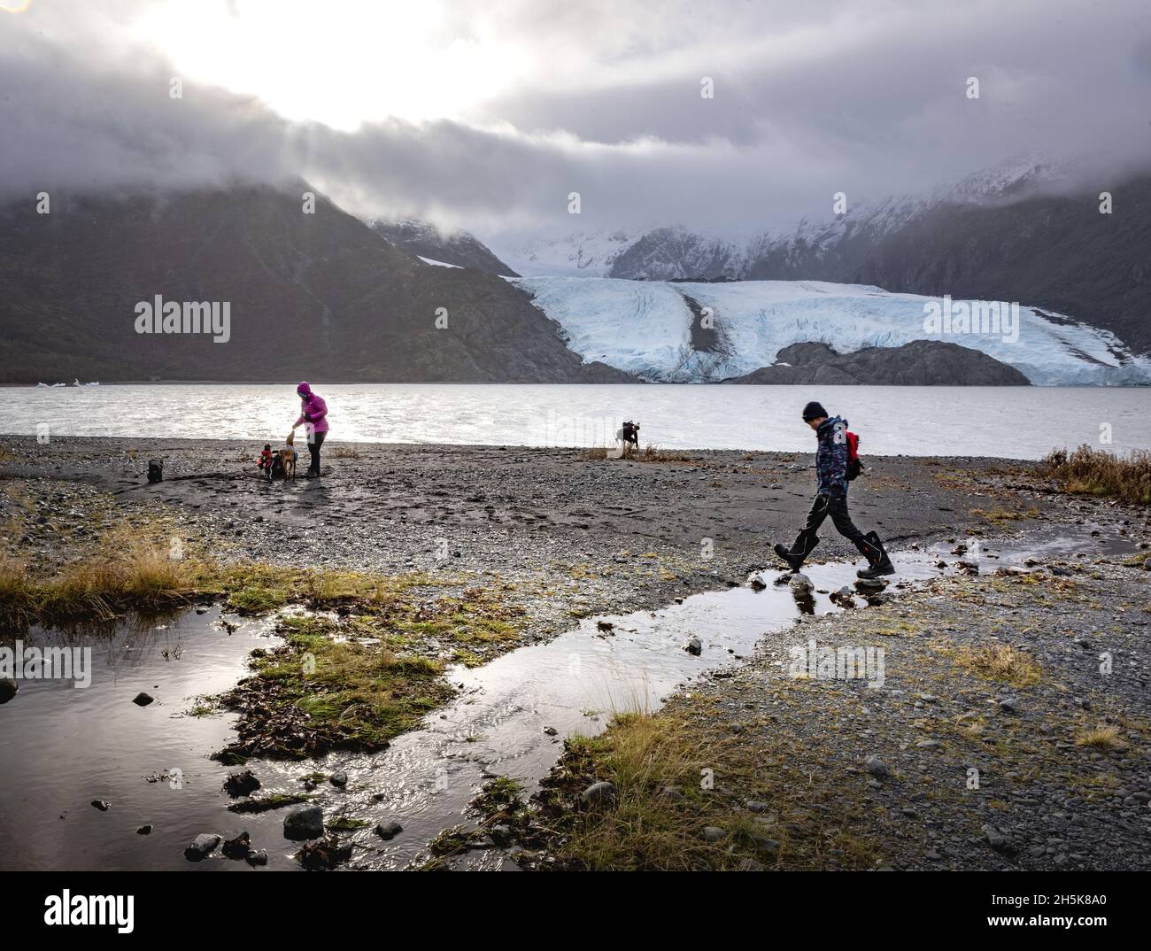 People exploring the shoreline of Portage Lake at the Portage Glacier ...