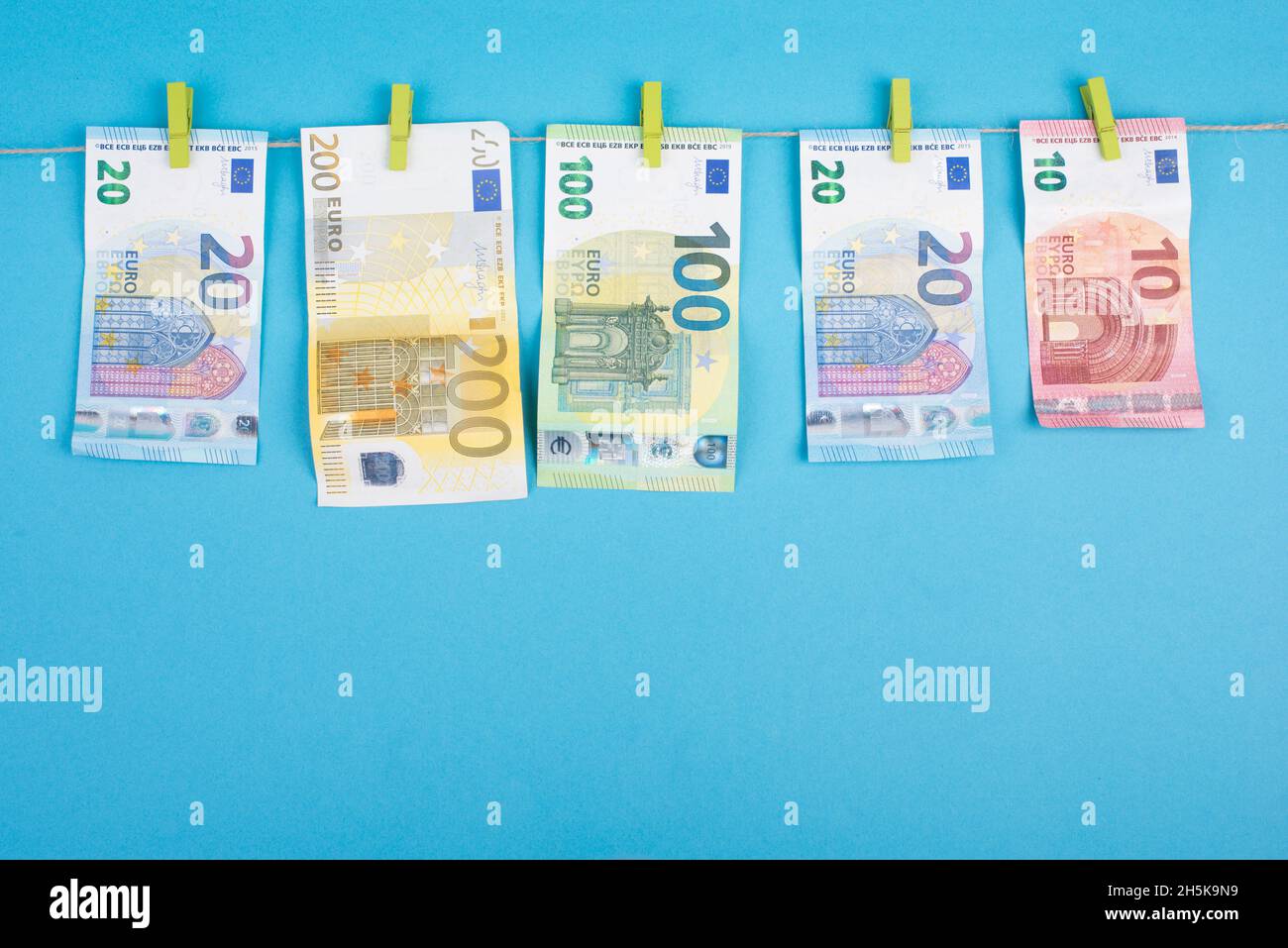 Money is hanging on a washing line, blue background, copy space, Euro ...