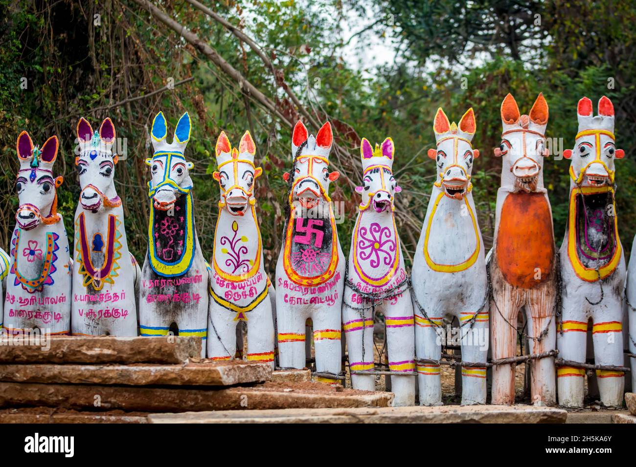 Painted, terracotta horse statues at the Sri Solai Andavar Temple in ...
