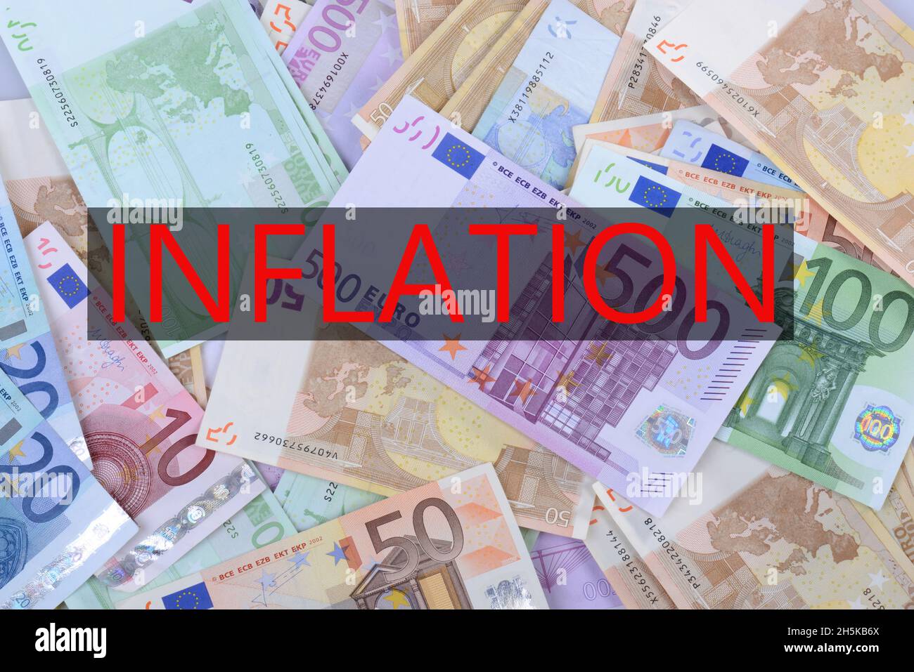 Pile of Euro banknotes, the word inflation is standing in the middle ...