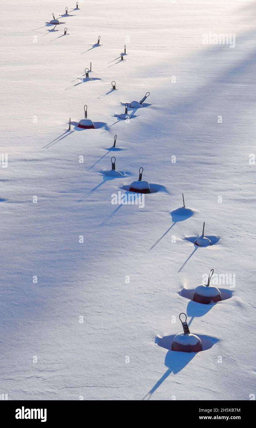 Frozen anchor buoys in snowy Finland Stock Photo - Alamy
