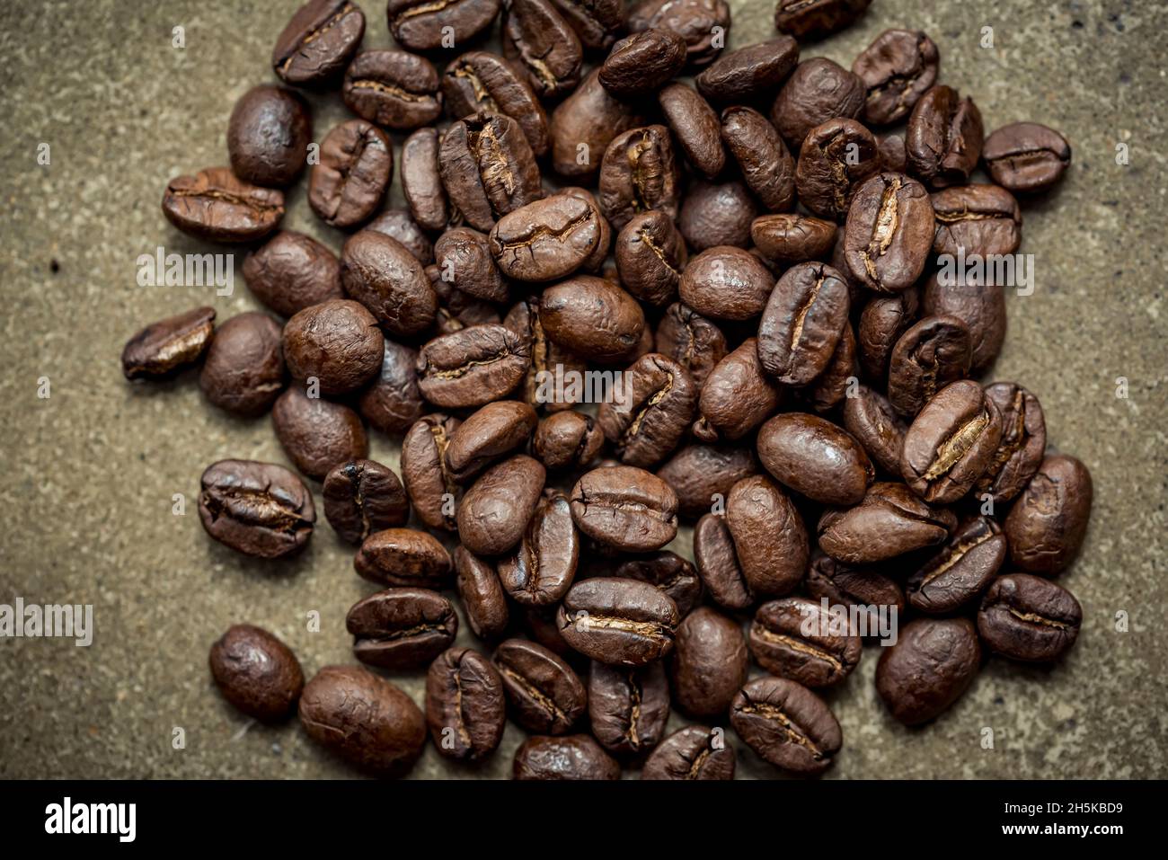 Roasted coffee beans on a grey surface; Studio Stock Photo - Alamy