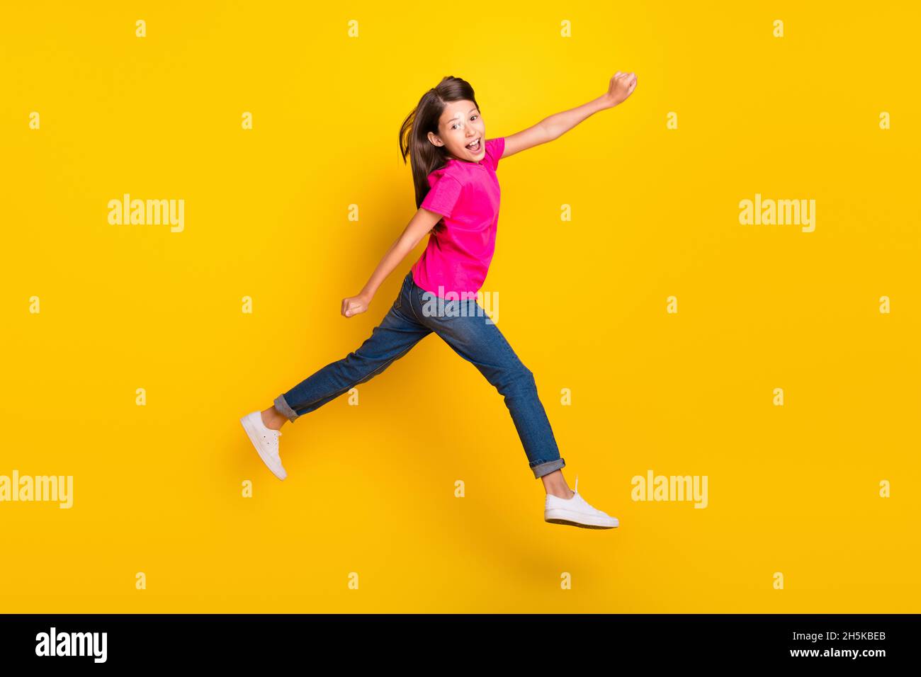 Photo of funky hurry sporty girl jump run fast rush side wear pink t ...