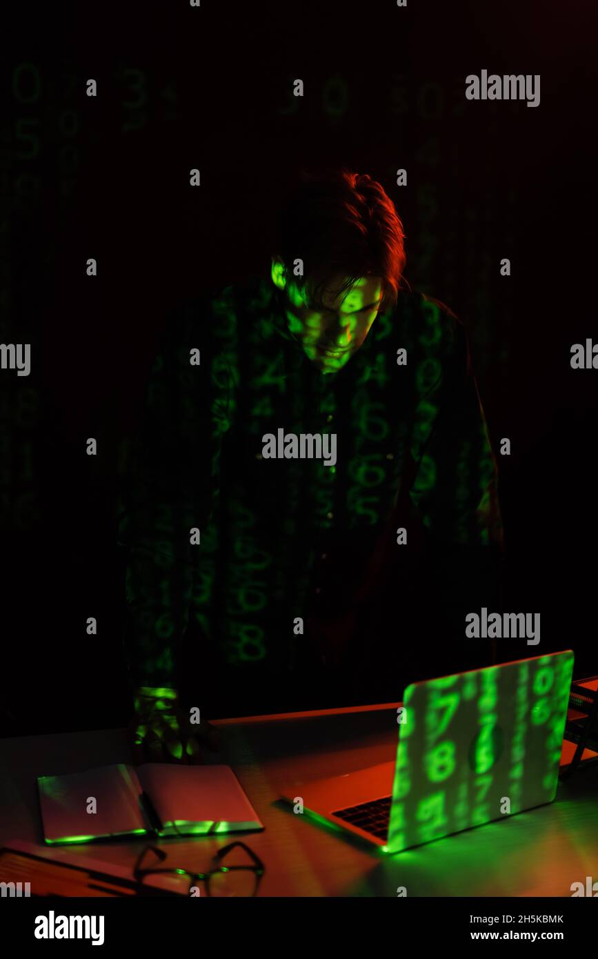 Programmer with reflection of computer code looking at laptop isolated ...