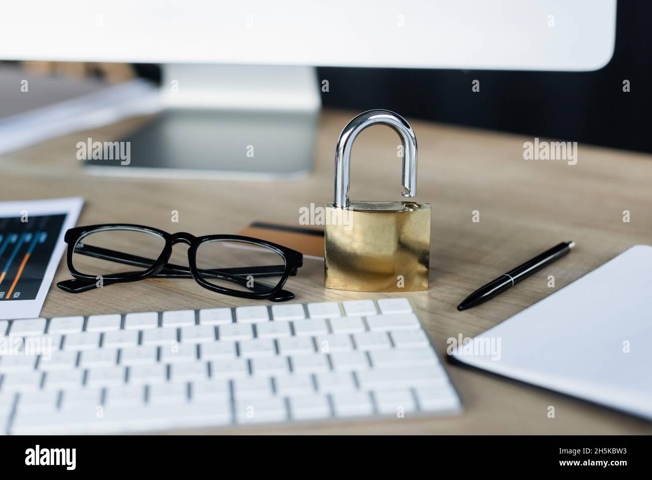 Padlock near eyeglasses and computer on table in office Stock Photo - Alamy