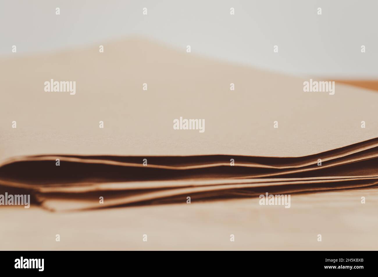 folded brown paper on a rustic wooden background with space for text ...