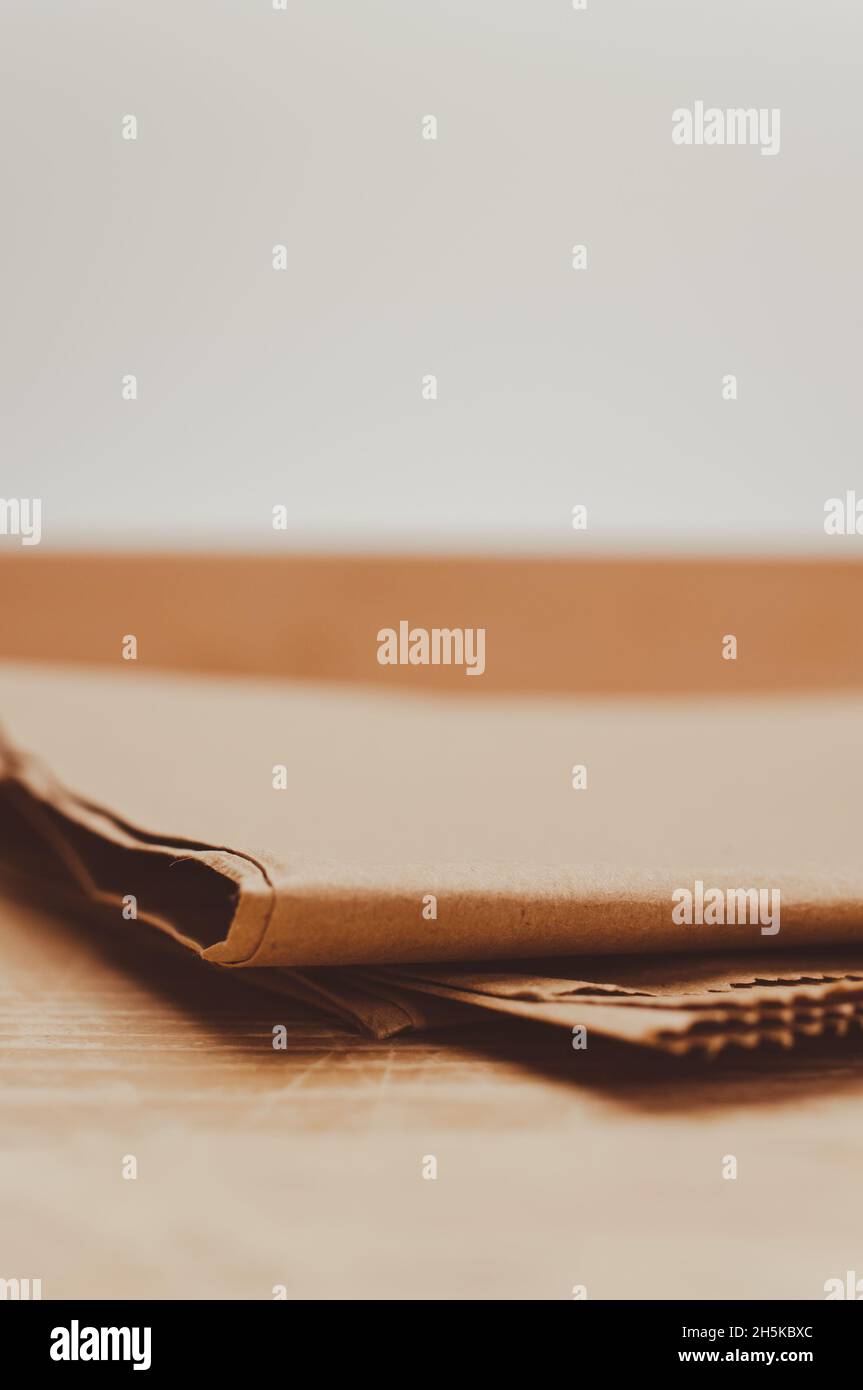 folded brown paper on a rustic wooden background with space for text ...