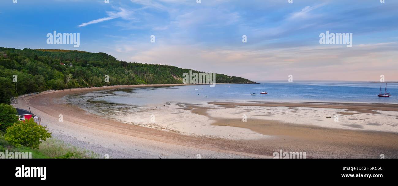 Sand beach along the shoreline at the village of Tadoussac, at the ...