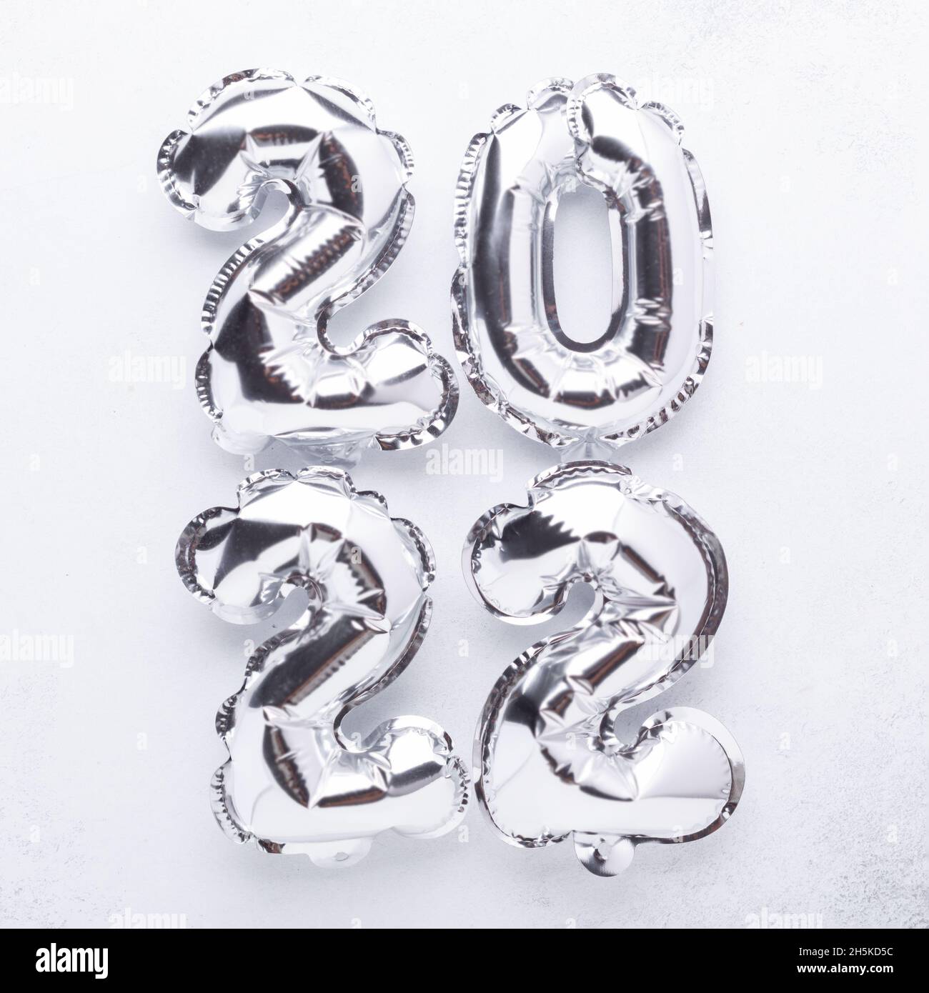 Silver balloons in the form of numbers 2022 on white background. New ...