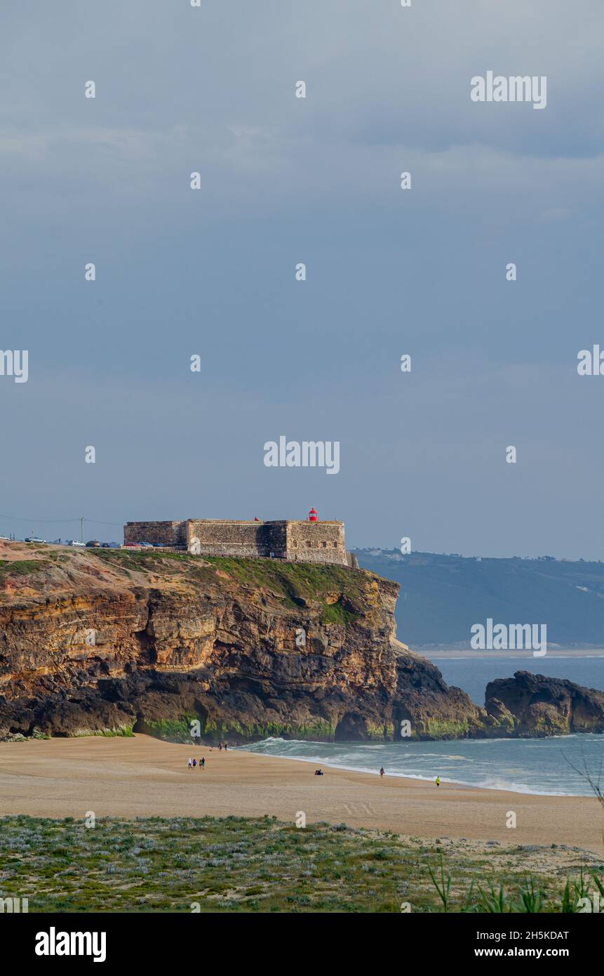 Praia do Norte beach, cliffs and Nazare lighthouse cape Stock Photo - Alamy