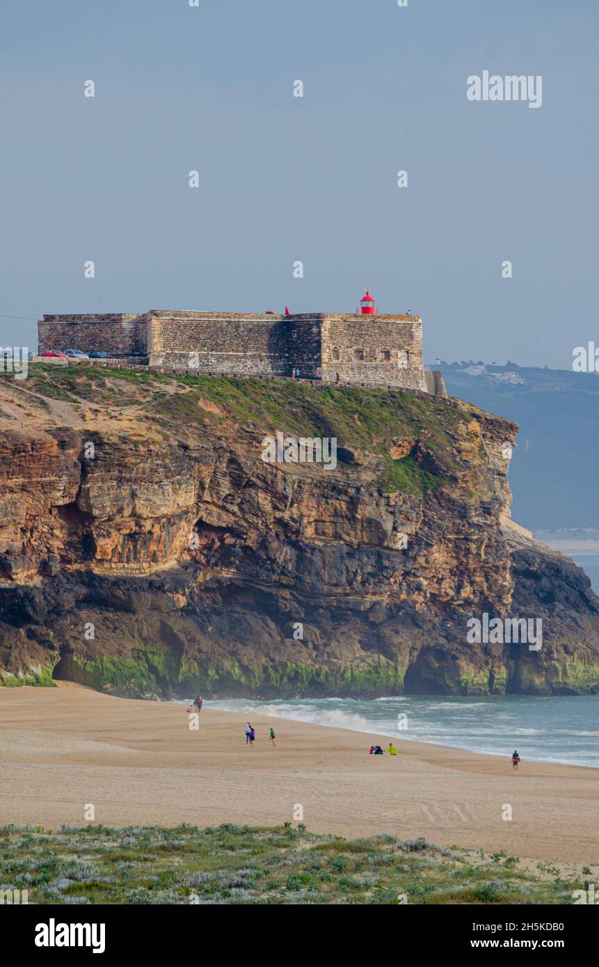 Praia do Norte beach, cliffs and Nazare lighthouse cape. Portugal Stock ...