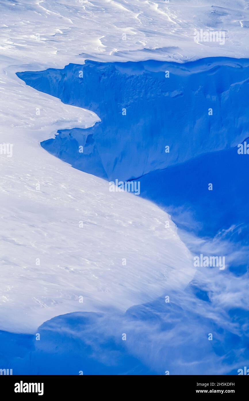 A cornice, an overhanging edge of snow formed by wind blowing snow over ...