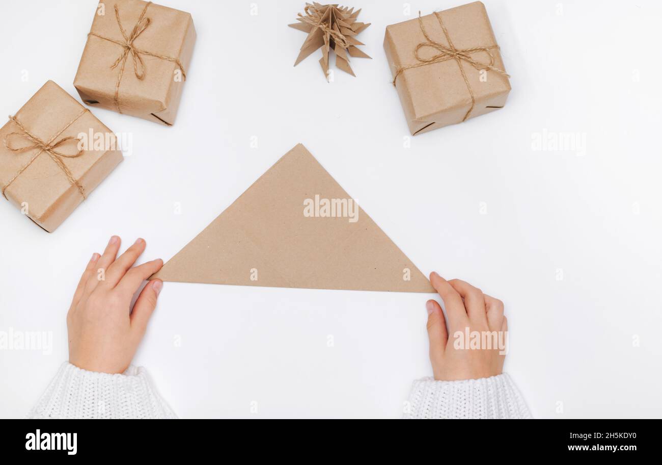 Christmas tree origami paper craft. The child performs the Step-by-step ...