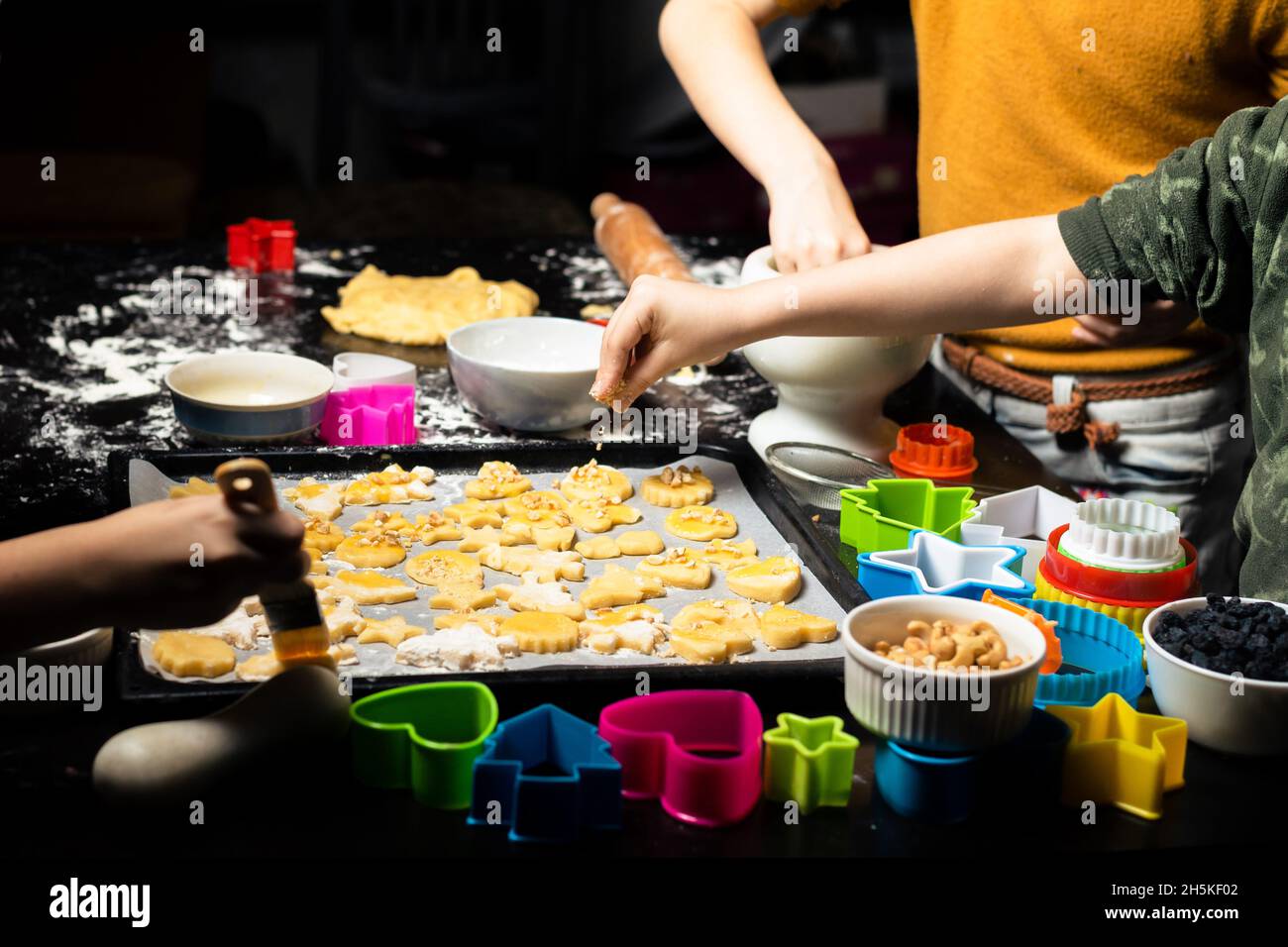 Making cookies by children. Cookies of different shapes are laid out on ...