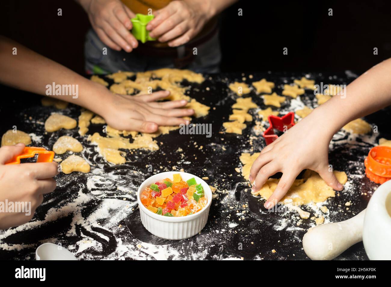 Children are busy cooking shortbread cookies on a dark background Stock ...