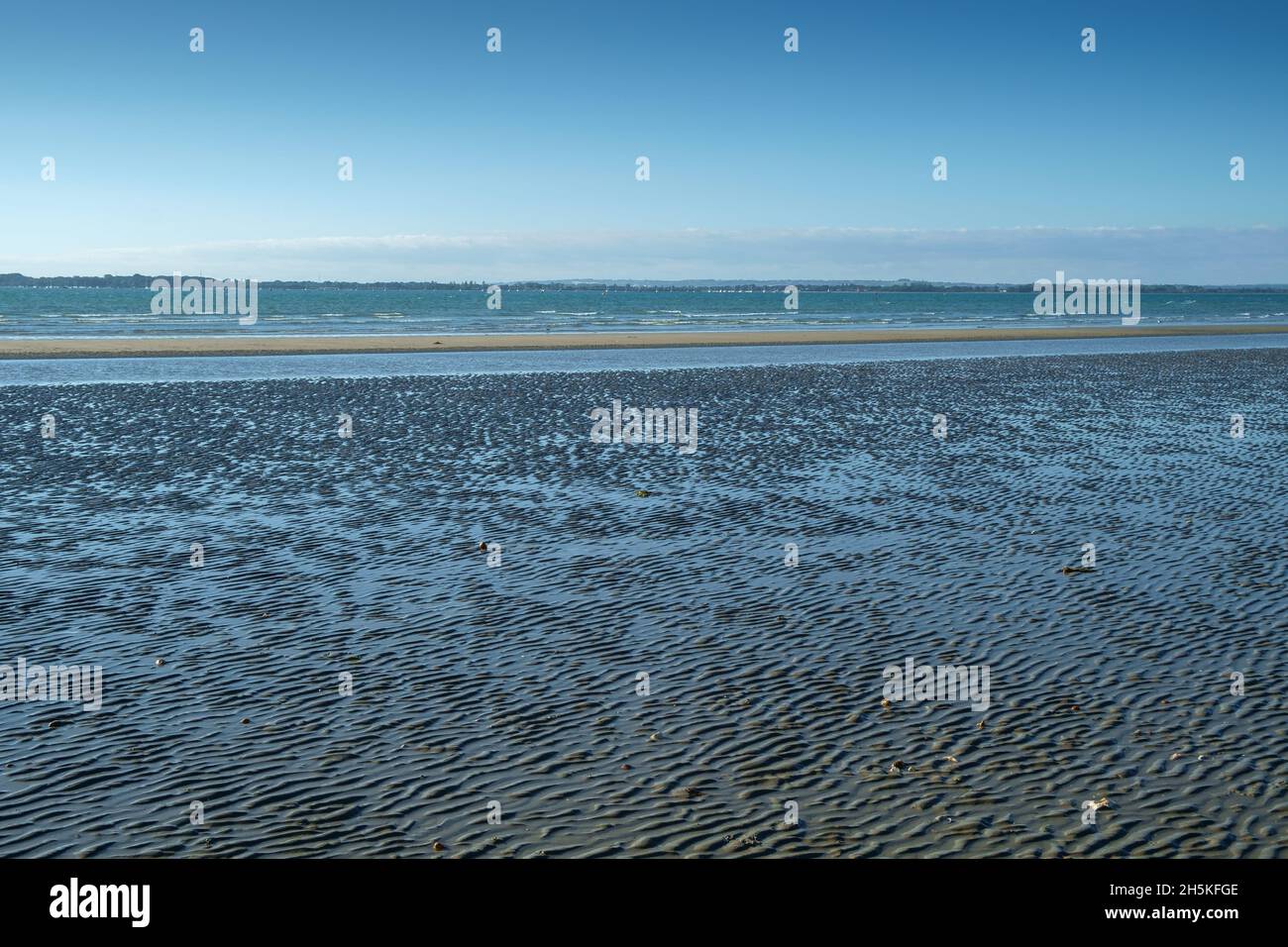 The rippled sand on the beach at low tide, West Wittering, Chichester ...
