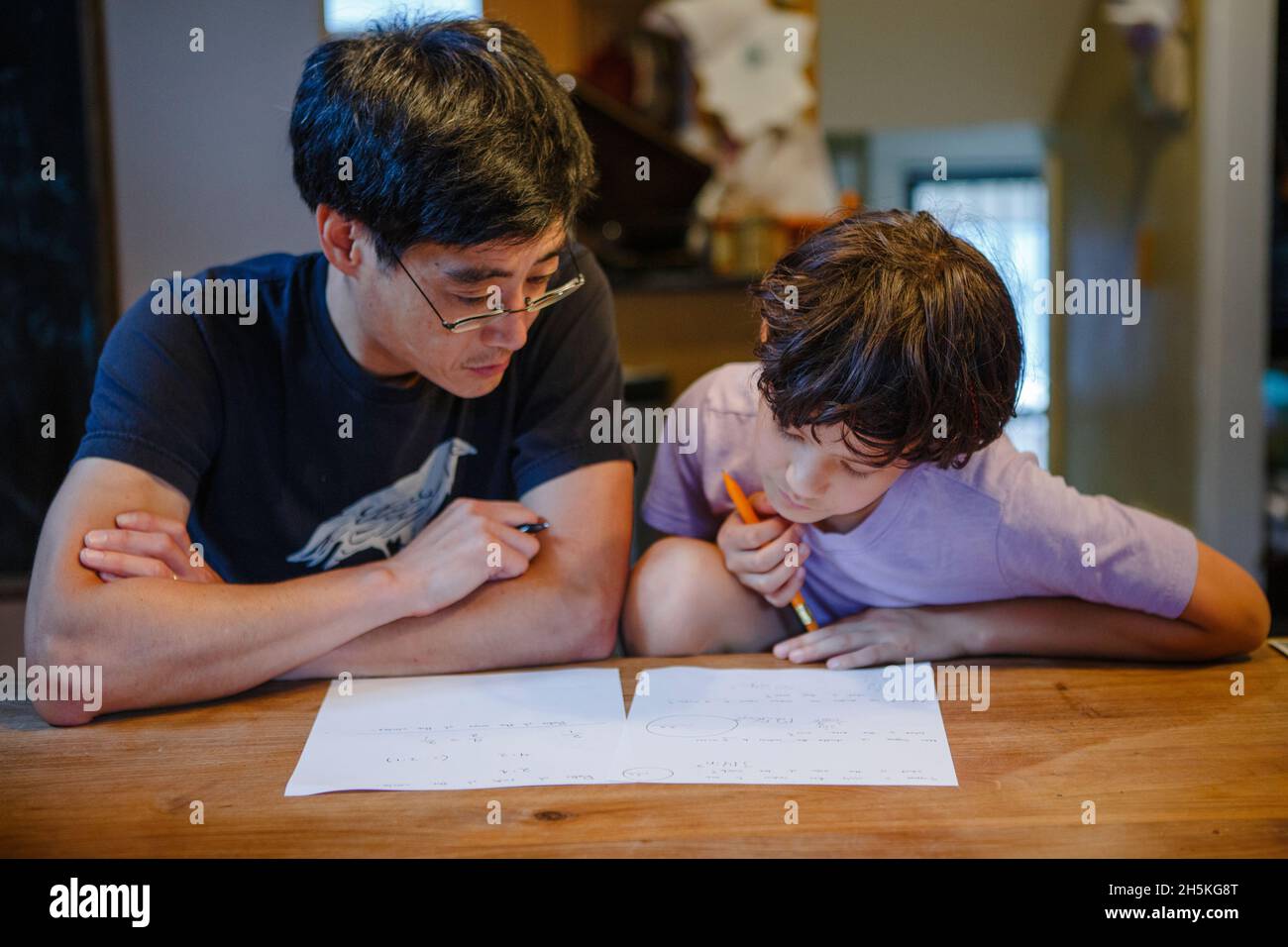 Teen boy doing homework with dad hi-res stock photography and images ...