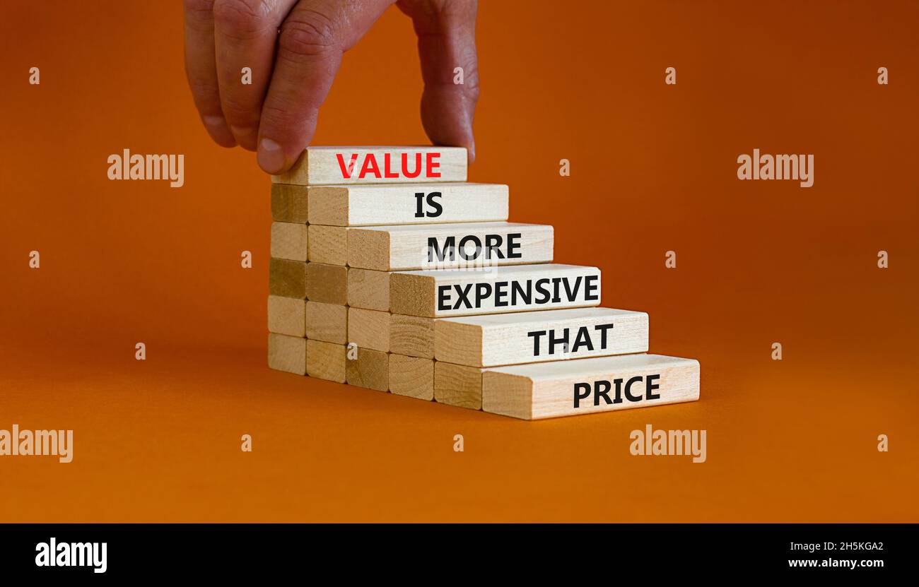 Price or value symbol. Wooden blocks with concept words Value is more ...