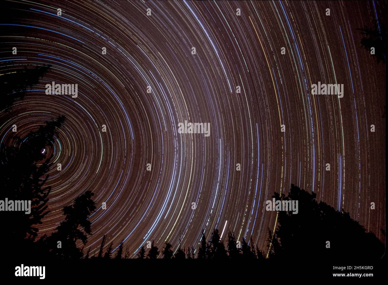 Long exposure of stars creating star track patterns in the night sky ...