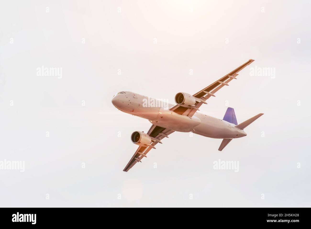 Airplane flying in the sky with bright light in the sky Stock Photo - Alamy
