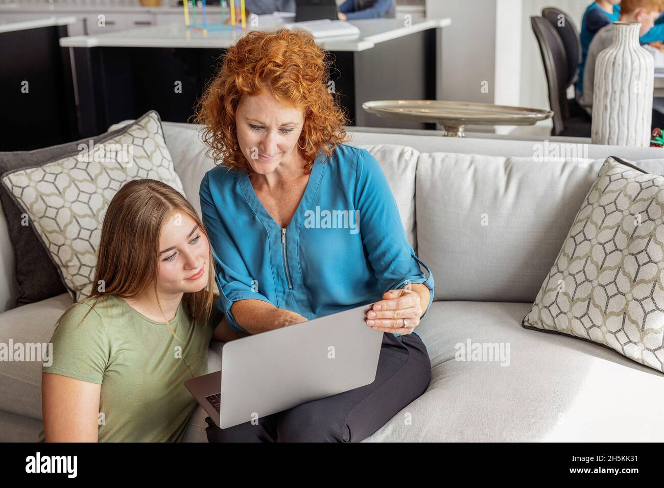 Mother and daughter looking at a laptop computer together; Edmonton ...