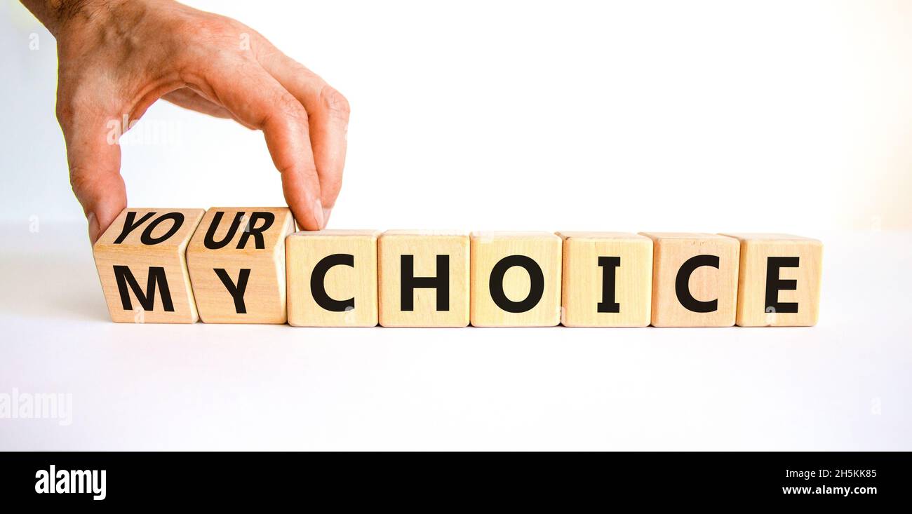 My or your choice symbol. Businessman turns wooden cubes and changes ...