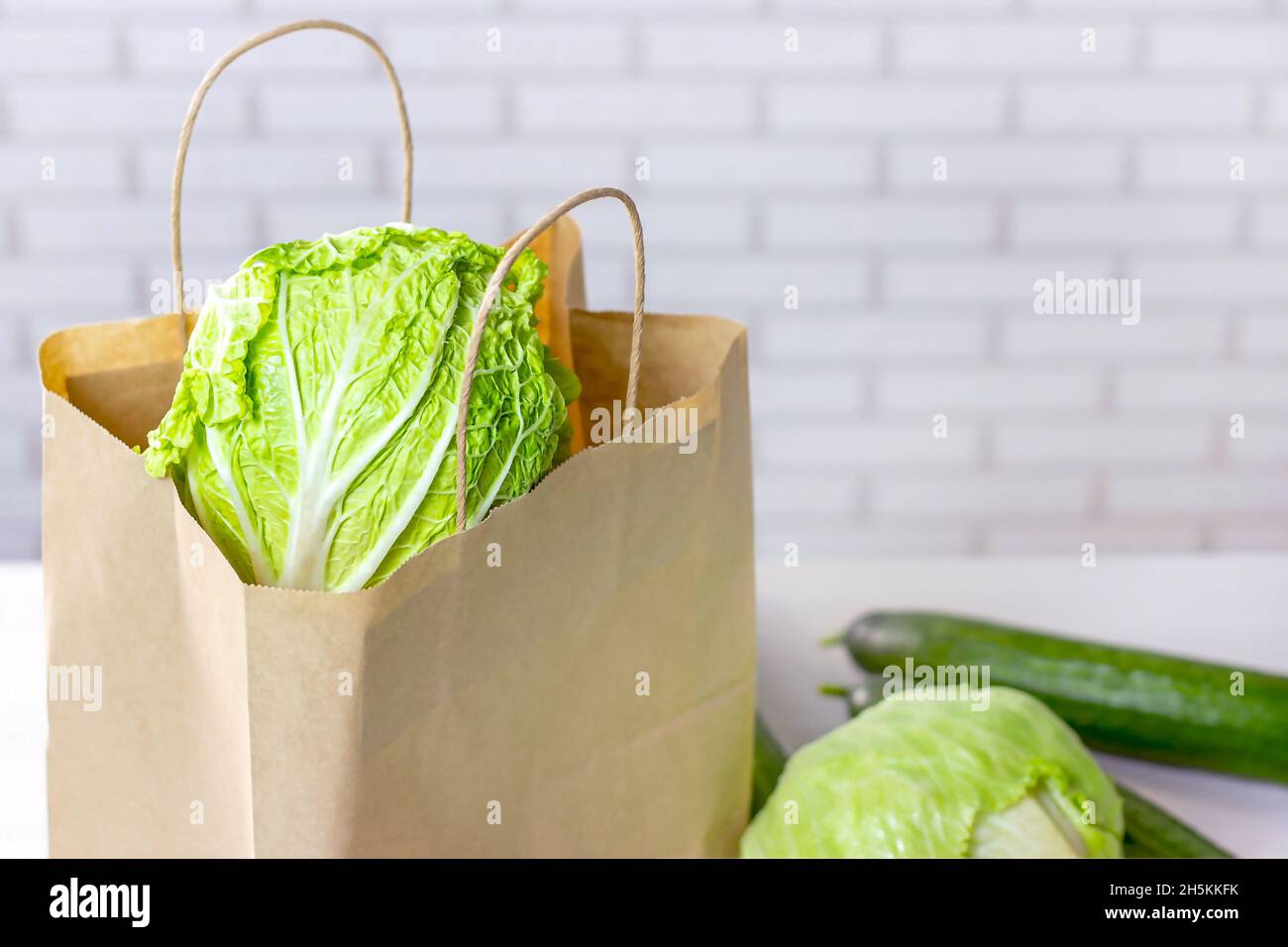 Craft paper bag with green vegetables from online shopping home ...