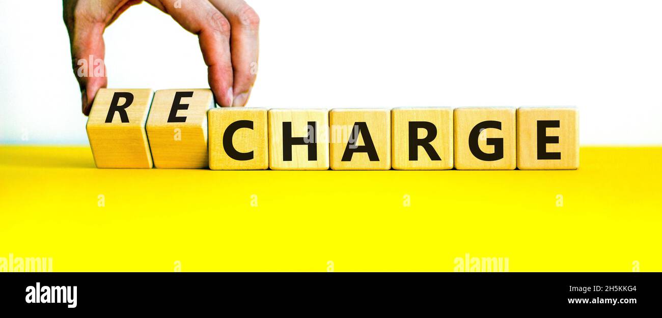 Charge or recharge symbol. Businessman turns wooden cubes and changes ...