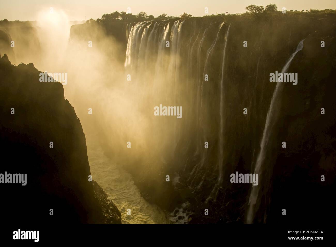 Sunlight illuminates mist rising from Victoria Falls Stock Photo - Alamy