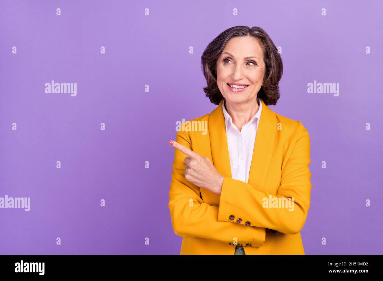 Photo of nice brunette old lady indicate look empty space wear yellow ...