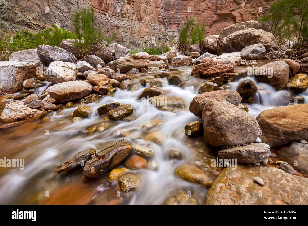 A fast moving creek flows over desert rocks Stock Photo - Alamy
