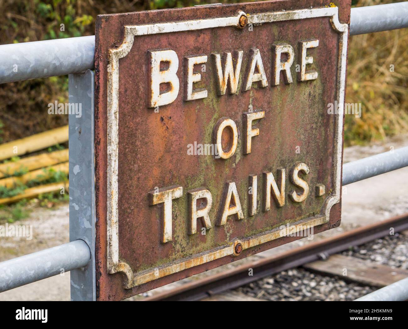 Close up of vintage 'Beware of Trains' sign at heritage railway company ...