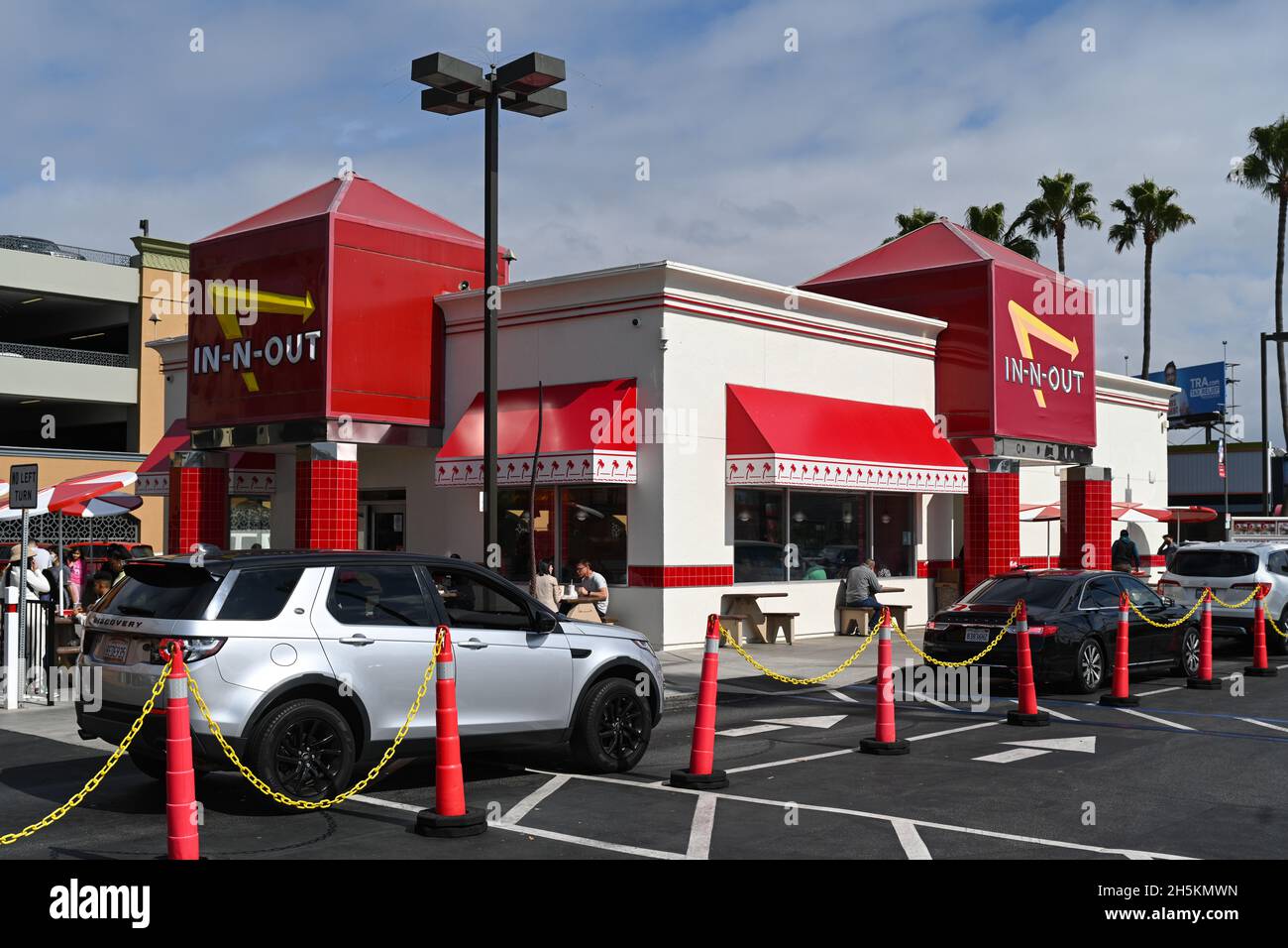 Drivers wait in the drive-thru line at an In-N-Out Burger restaurant in ...