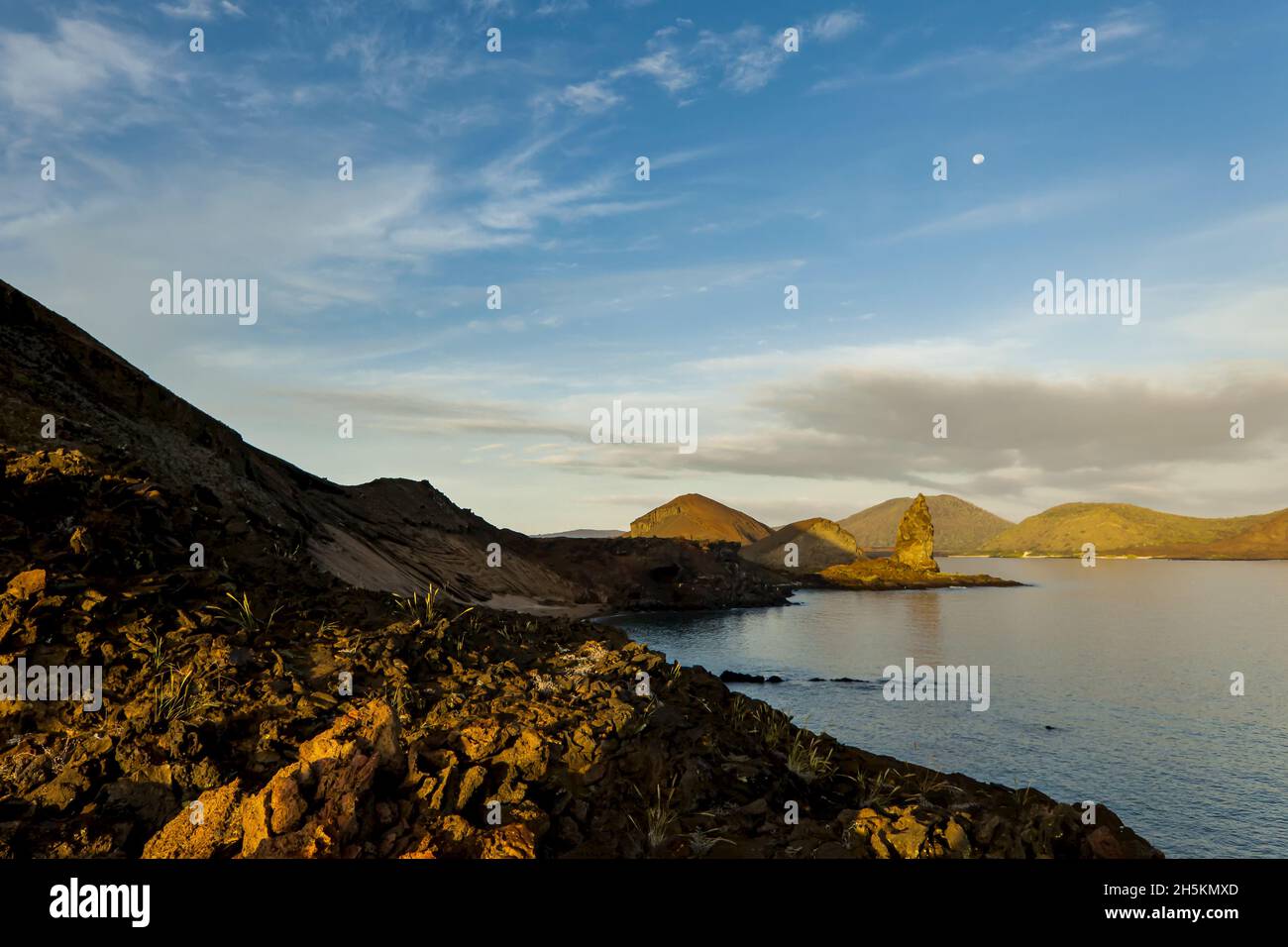 Moon rise over landscape of volcanic rock and water Stock Photo - Alamy