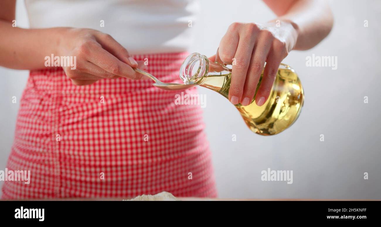 A woman is cooking with oil Stock Photo - Alamy