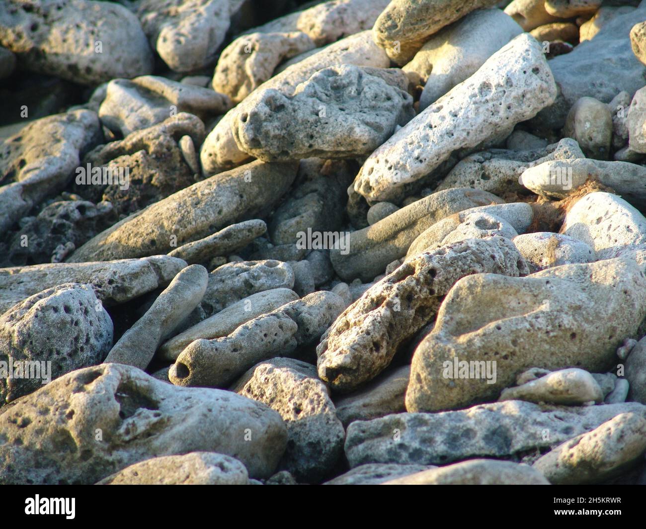 Closeup shot of a pile of odd-shaped natural stones under the sunlight ...