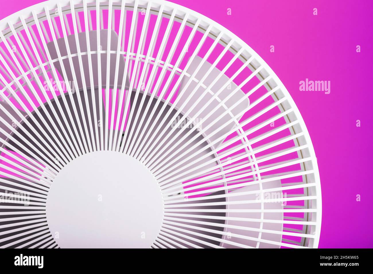 A high-tech white electric fan with a modern design for cooling the ...